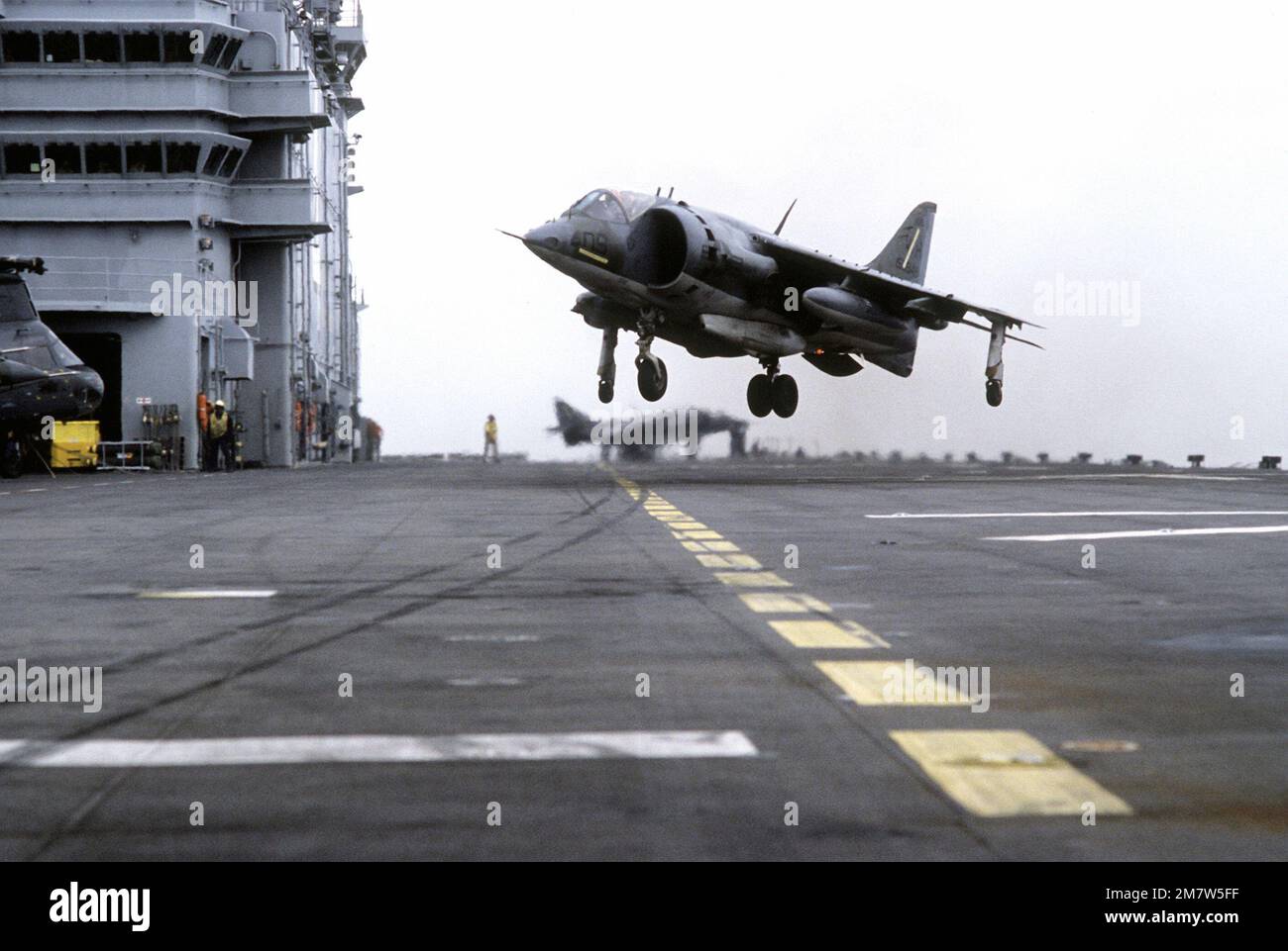 A left side view of an AV-8 Harrier aircraft taking off from the deck ...