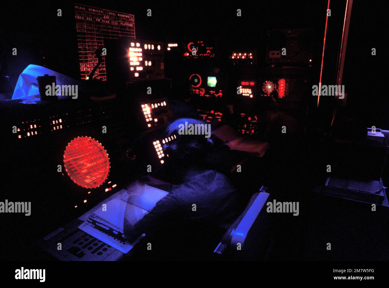 A crewman monitors a radar scope in the combat information center ...