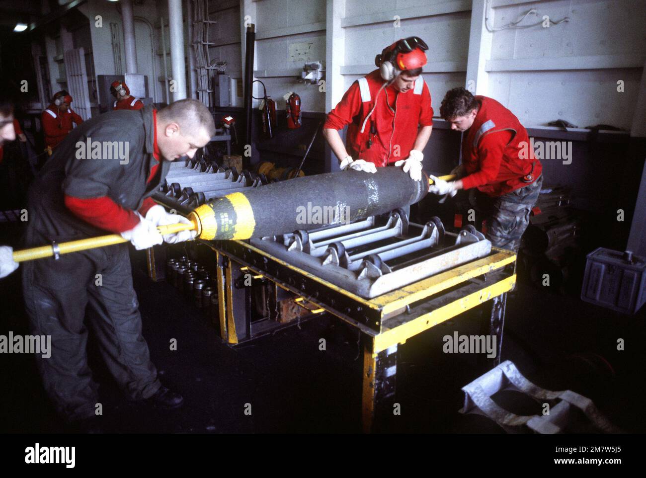 Marines arm a bomb aboard the amphibious assault ship USS NASSAU (LHA-4 ...