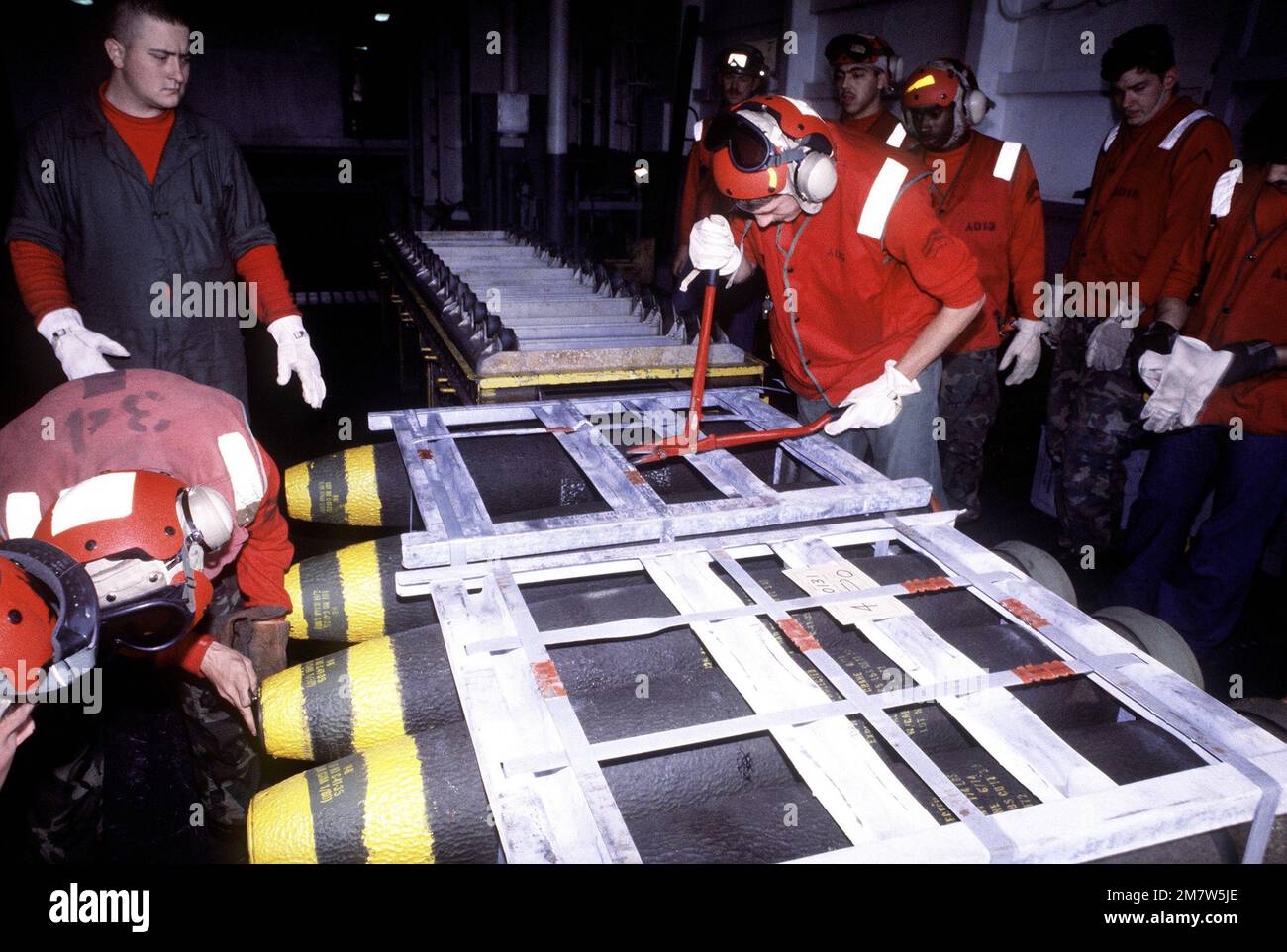Marines uncrate bombs aboard the amphibious assault ship USS NASSAU ...