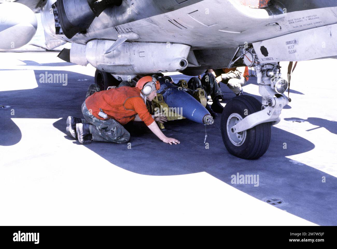 A bomb loader is used to lift and secure a bomb into position beneath ...