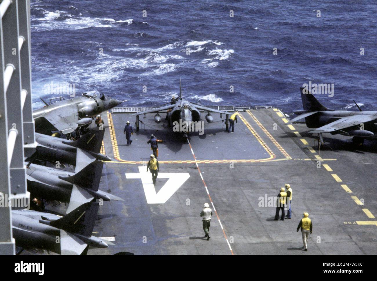 An AV-8A Harrier aircraft is prepared for takeoff aboard the amphibious ...