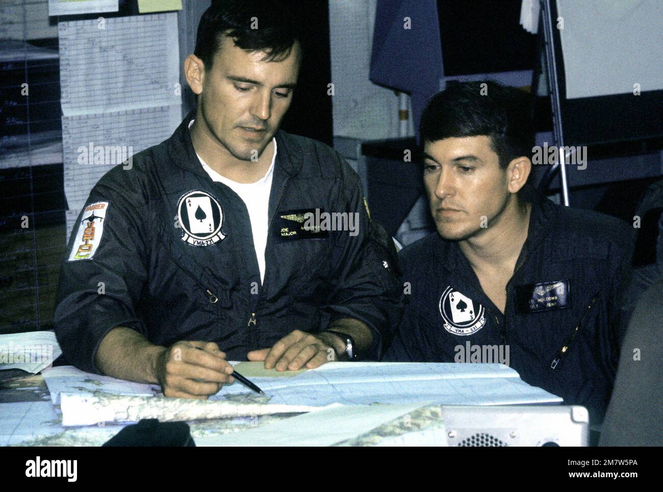 Members of Marines Light Attack Squadron 231 (VMA-231) look at a map ...