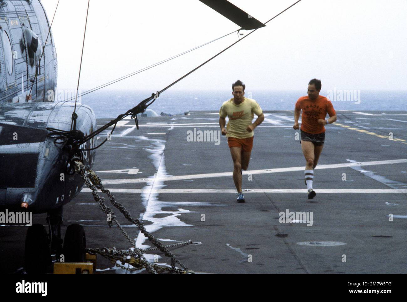 Marines run laps on the deck of the amphibious assault ship USS NASSAU ...