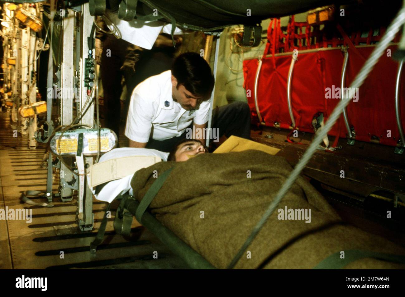 A member of the 82nd Airborne Division, injured in an air drop, is ...