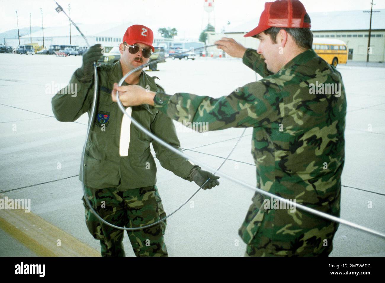 Personnel from the 2nd Mobile Aerial Port Squadron (MAPS) coil a cable ...