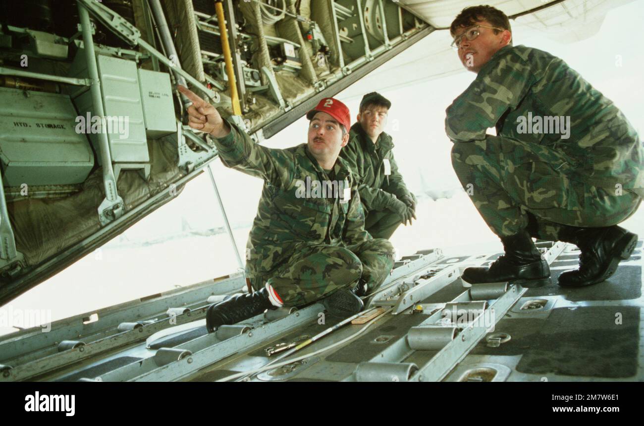 Personnel from the 2nd Mobile Aerial Port Squadron (MAPS) install cargo ...