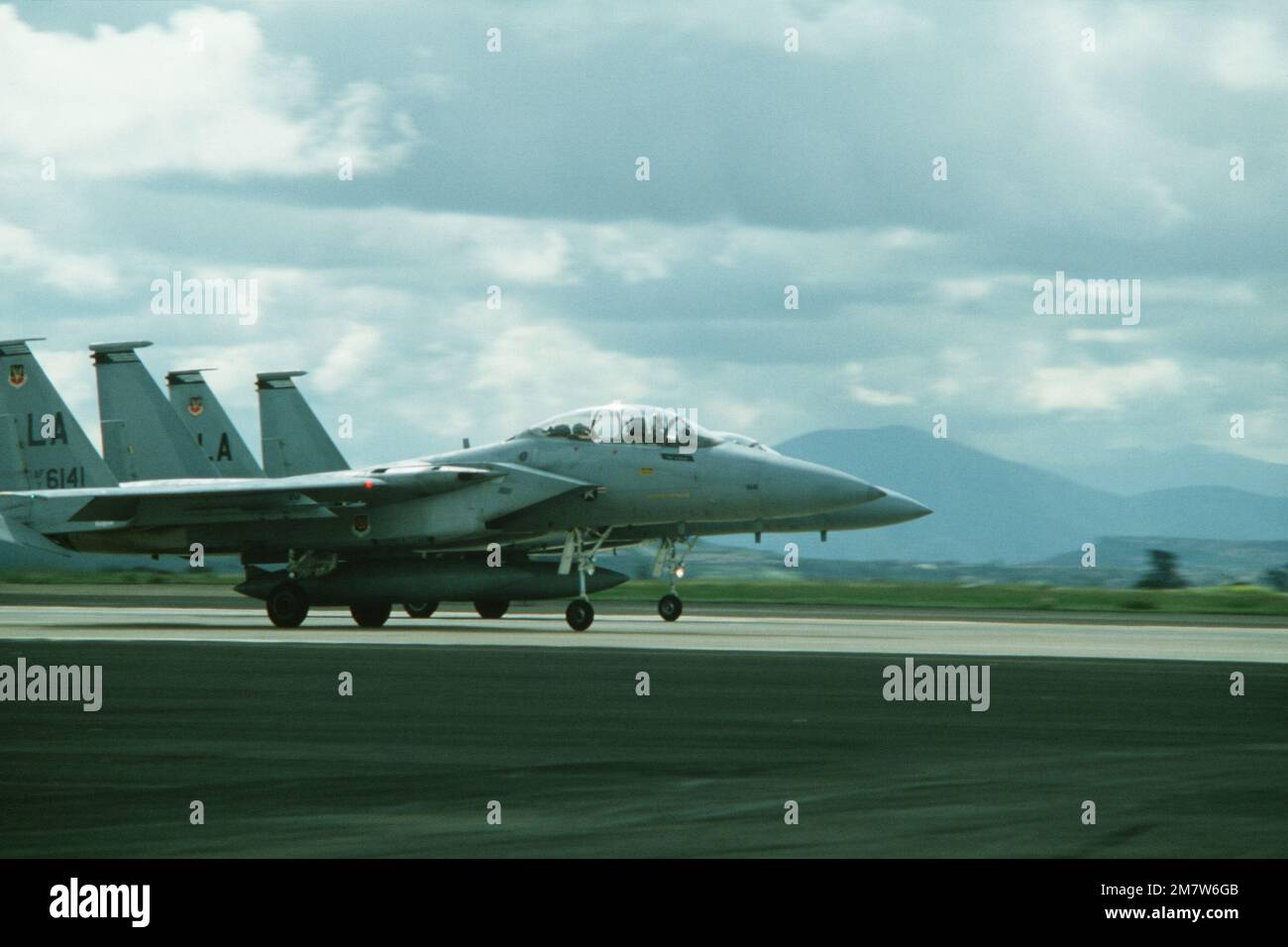 A right side view of two F-15 Eagle aircraft preparing for takeoff ...
