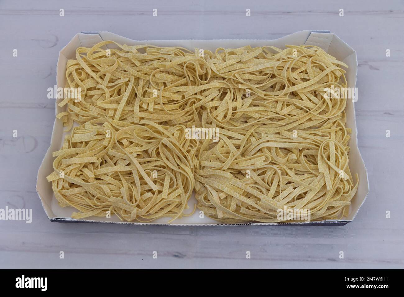 A Pile of Uncooked Noodles Up Close on a white background Stock Photo ...