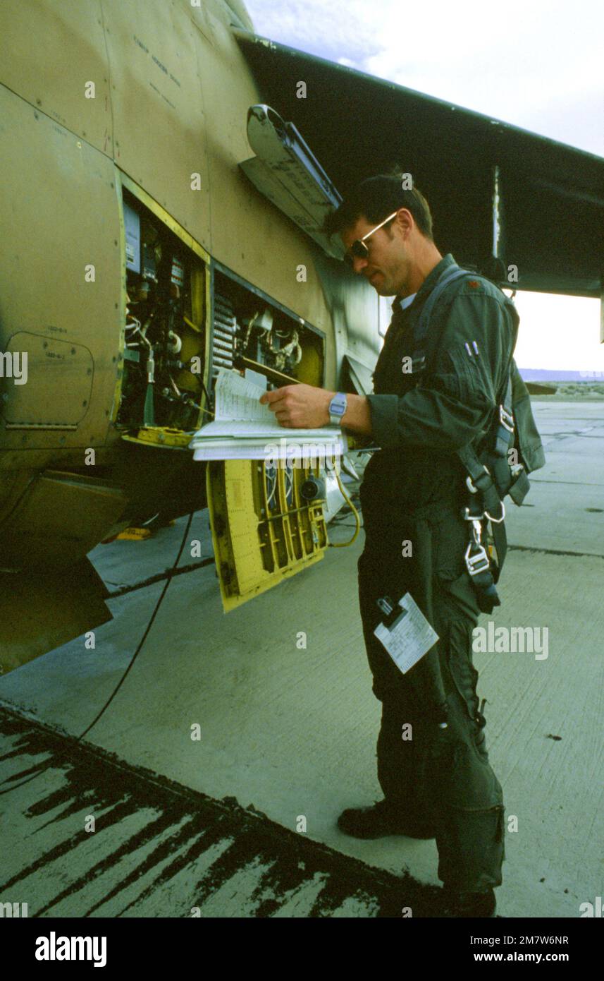 An A-7D Corsair II aircraft pilot reads maintenance forms while he ...