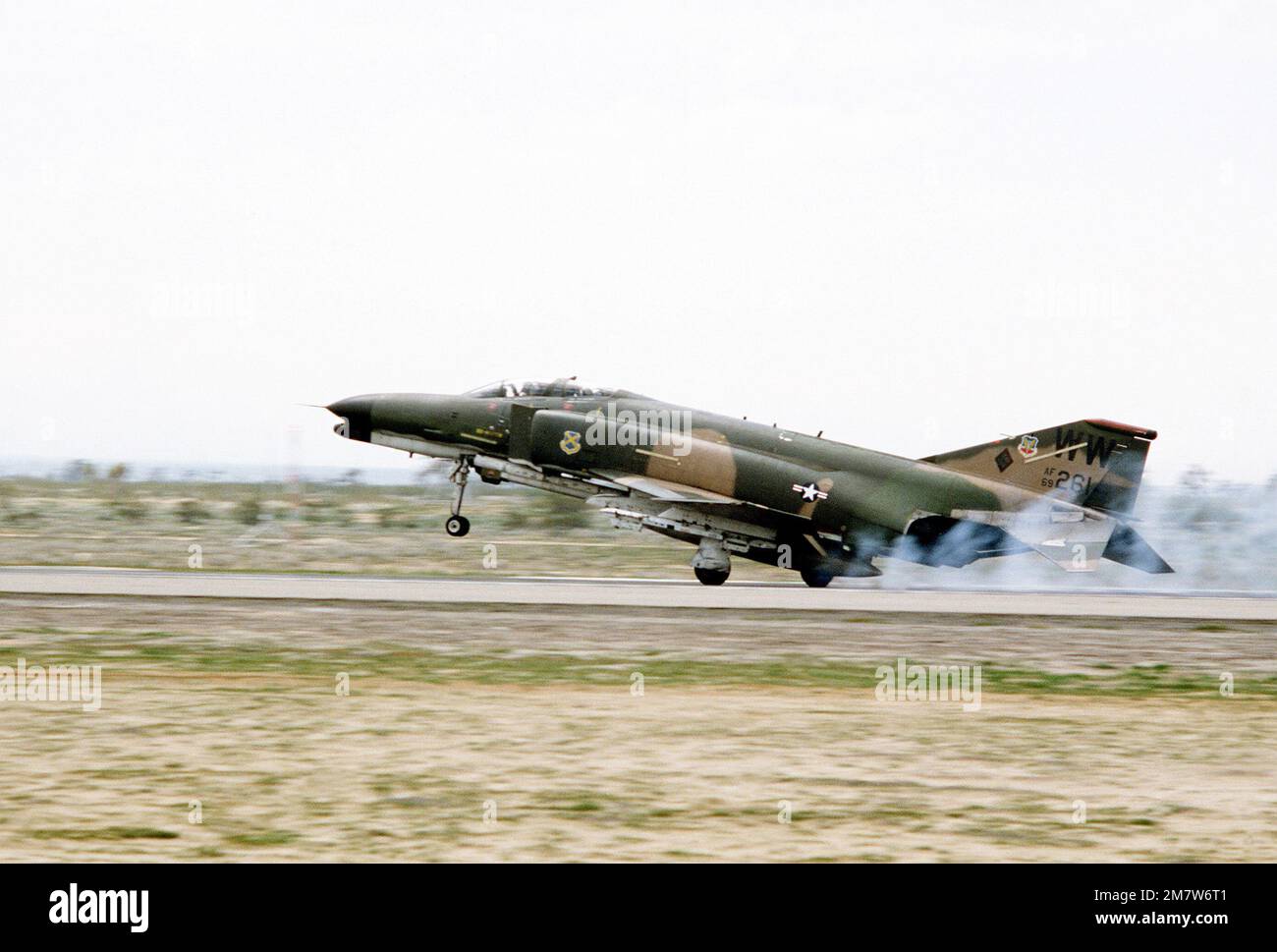 A left side view of an F-4 Phantom II aircraft taking off during ...