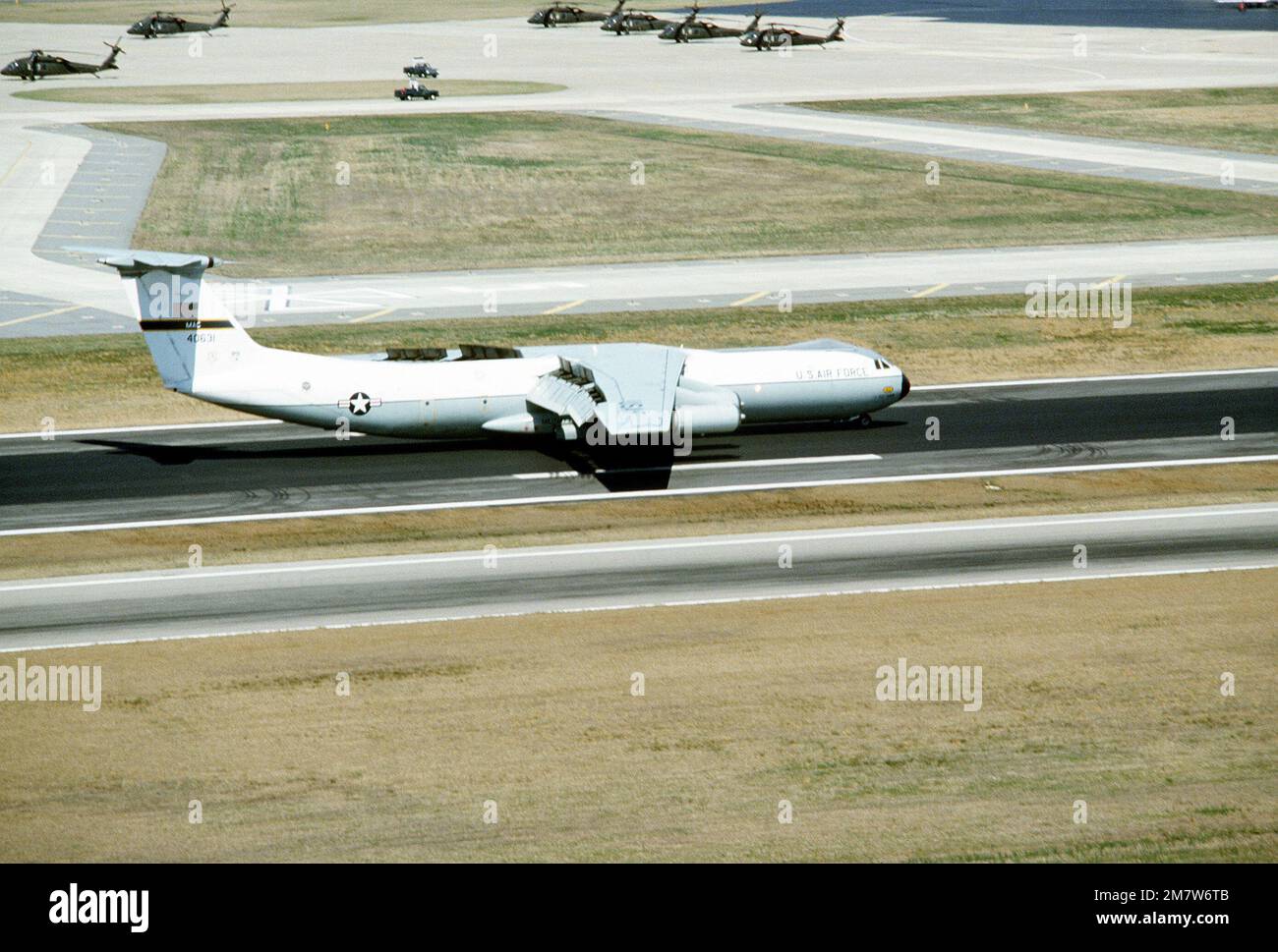A right side view of a C-141B Starlifter aircraft landing during ...