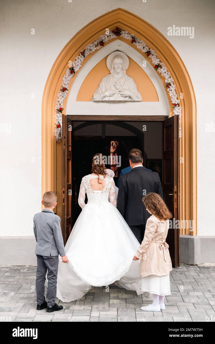 bride and groom waiting outside the church for the wedding ceremony ...