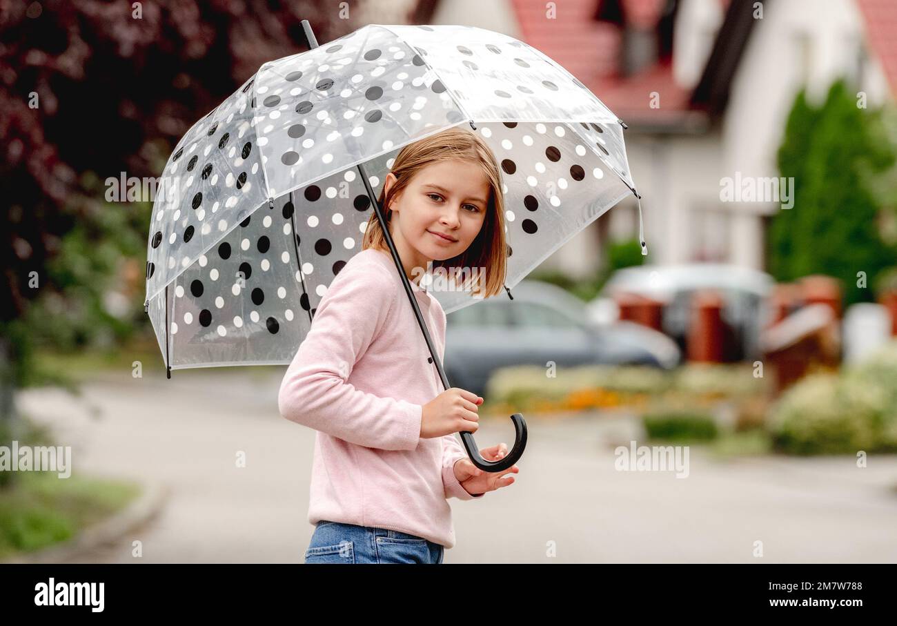 Preteen girl with umbrella Stock Photo - Alamy