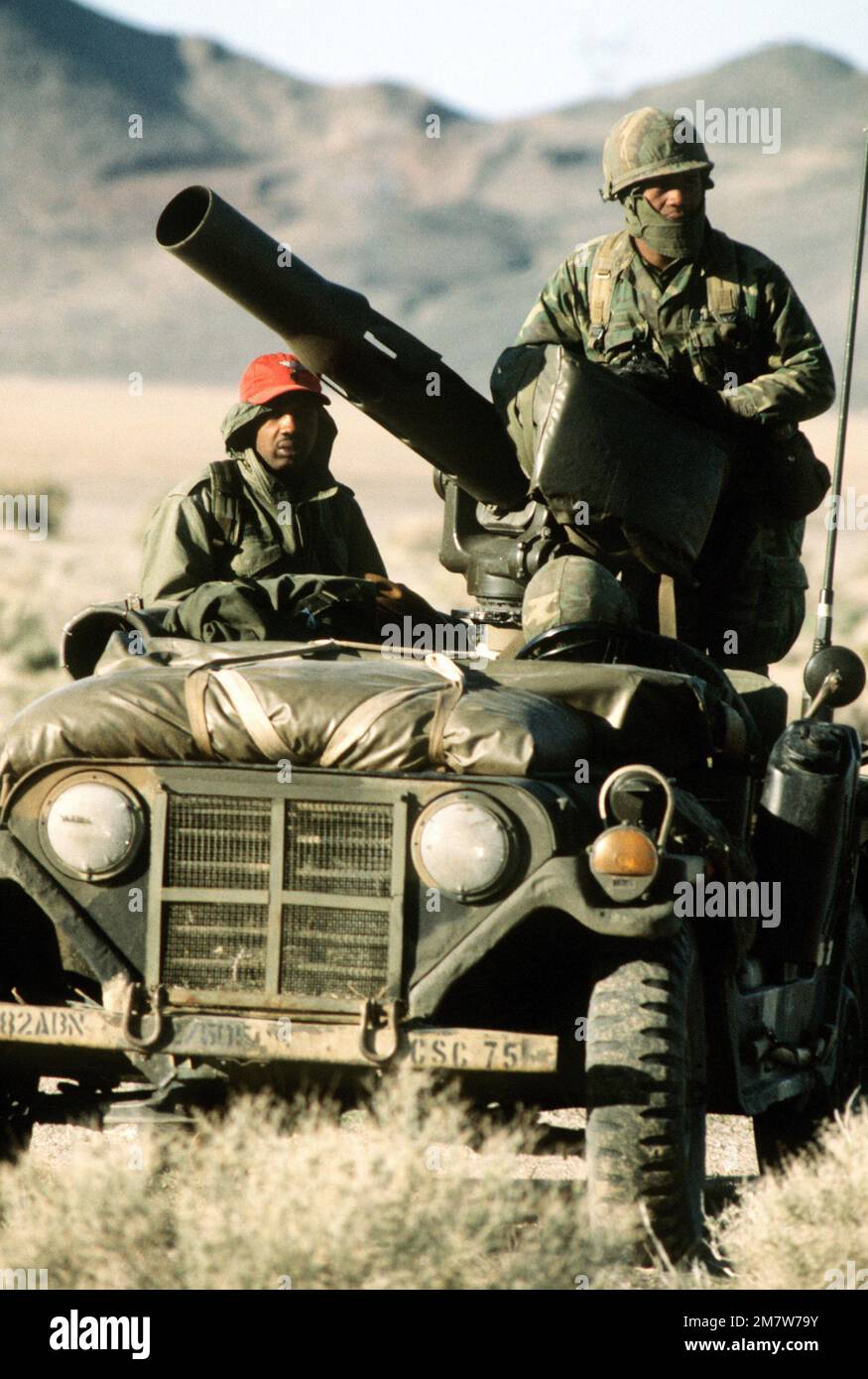 Members of the 82nd Airborne Division board a jeep that was air dropped ...