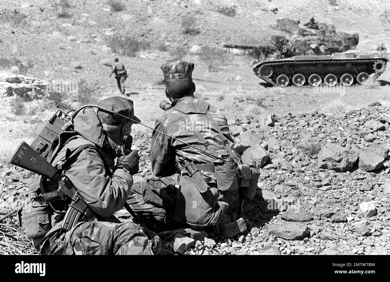 Two Marines from the 9th Marines, 1ST Marine Division, watch as an M ...