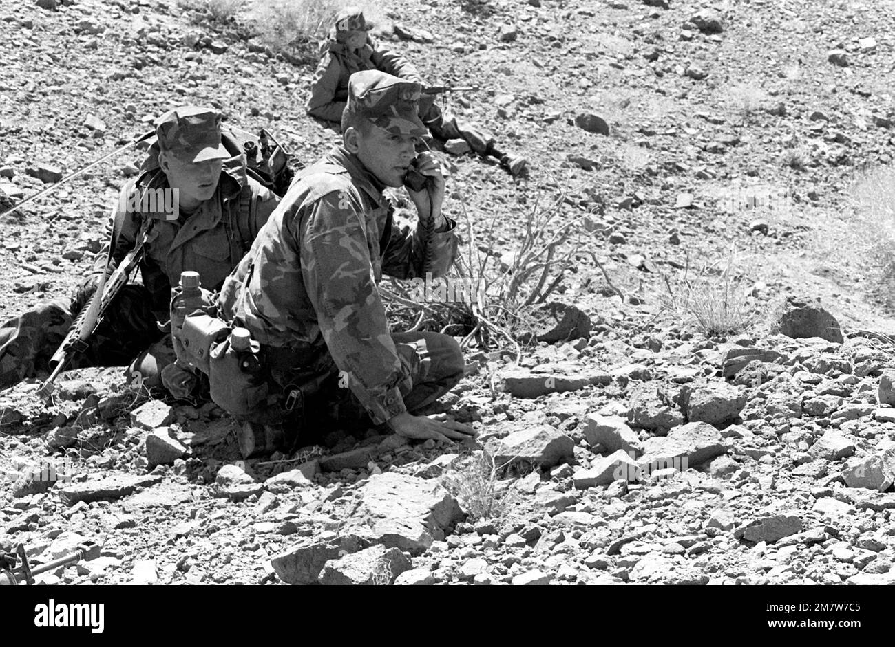 Two Marines from the 9th Marines, 1ST Marine Division, watch as an M ...