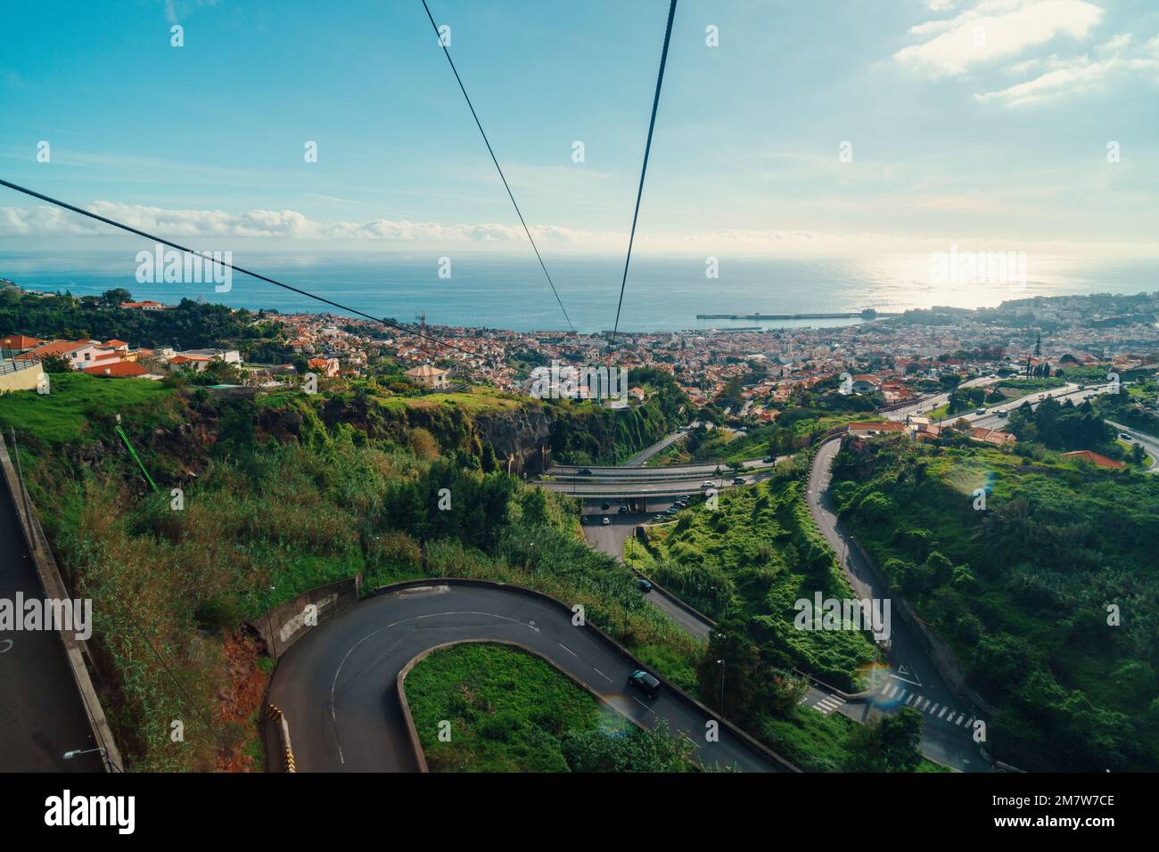 The aerial tramway cables over the buildings on the Medeira Island ...
