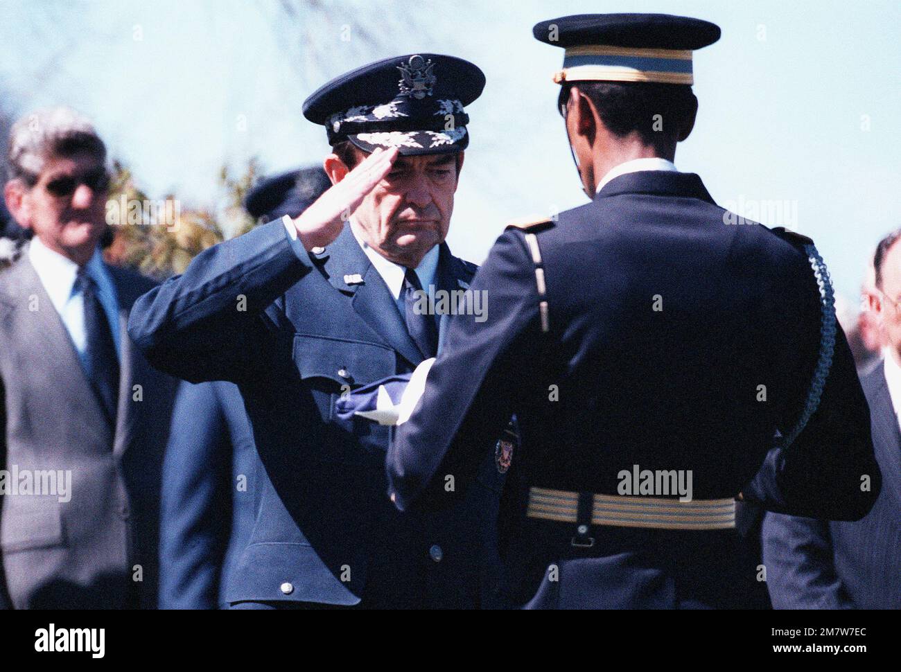 An Air Force honor guard hands the folded flag, from the coffin of GEN ...