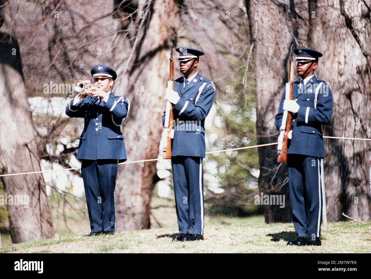 An Air Force bugler blows taps at the conclusion of the funeral service ...
