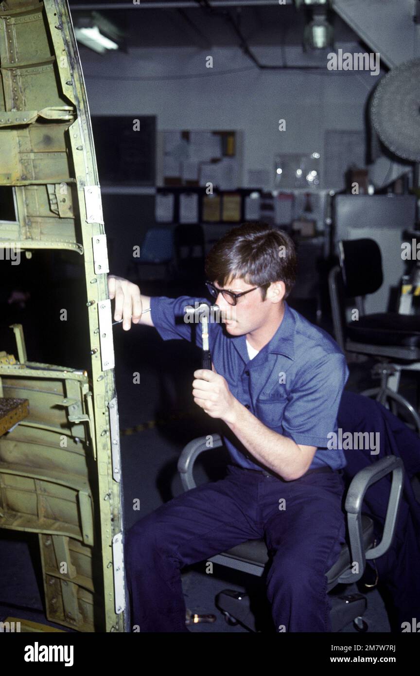 Aviation Structural Mechanic AMN Ernie Schmidt works on an A-7 Corsair ...