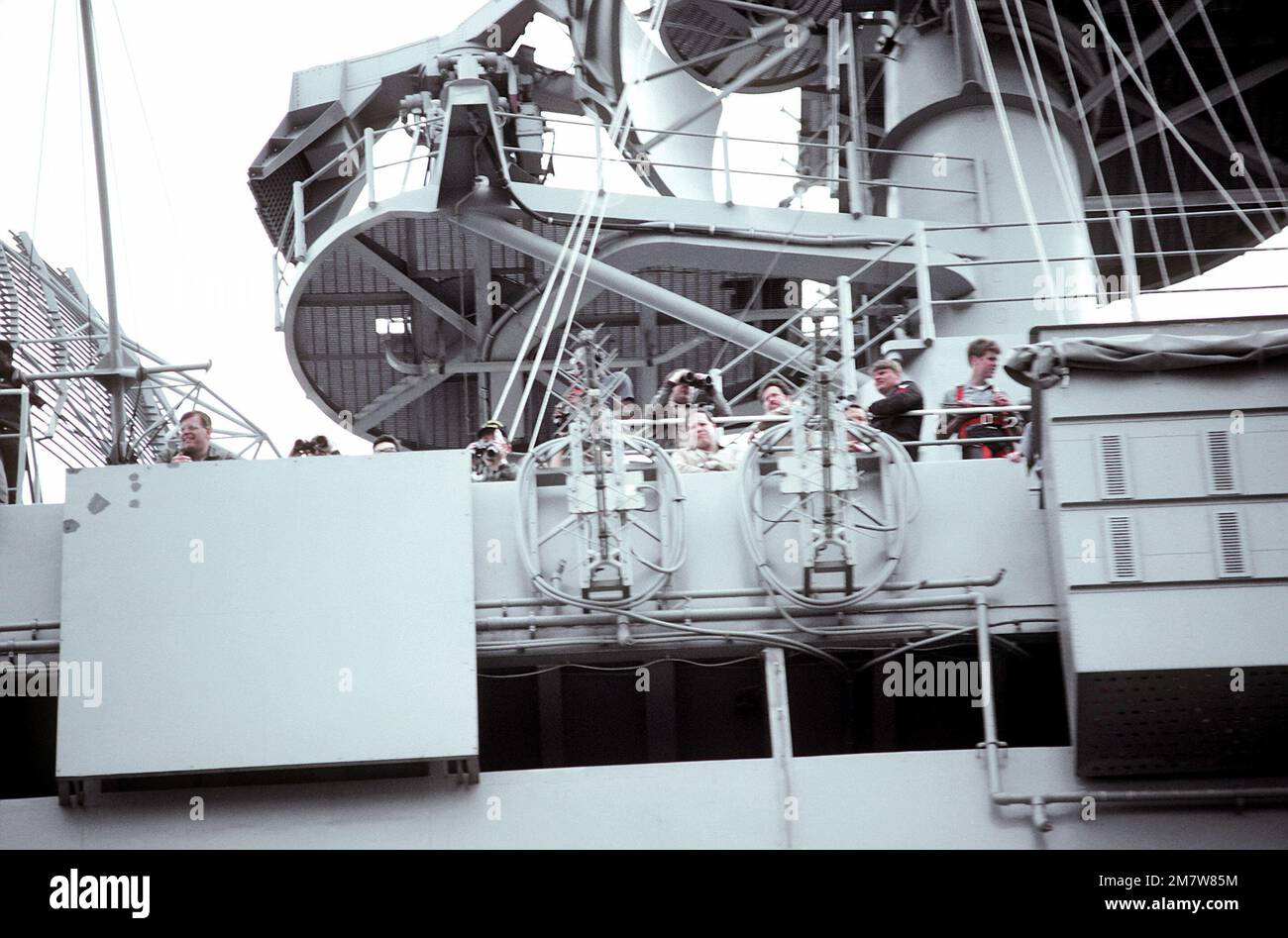 A view of crewmen standing on the superstructure of the nuclear-powered ...