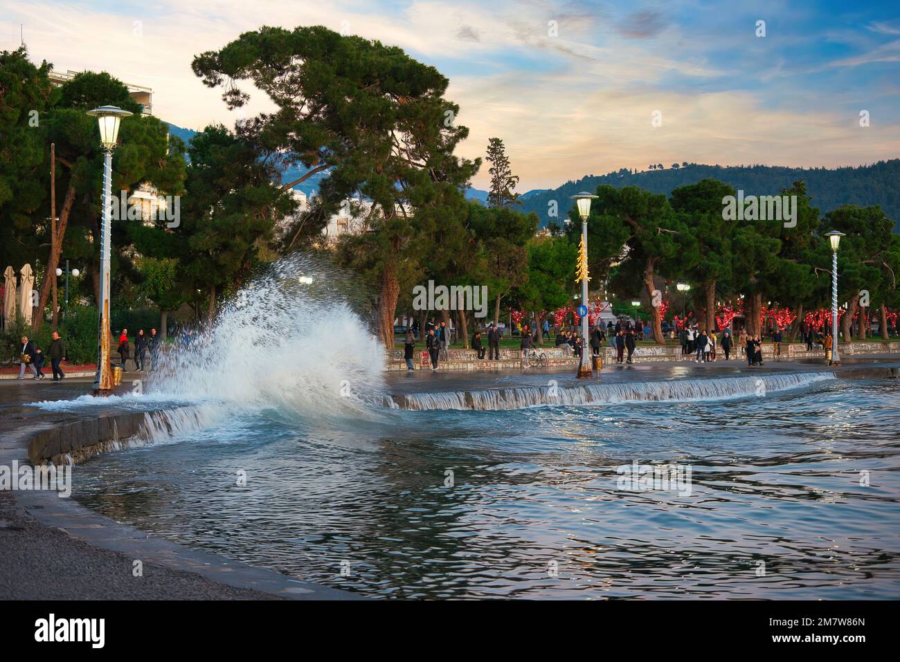 magnificent sunset in the harbor, wave crashing on the waterfront ...