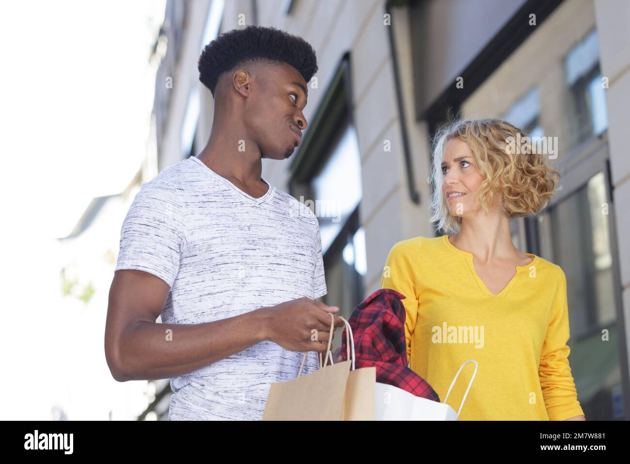couple takes out new clothes from shopping bagd Stock Photo - Alamy