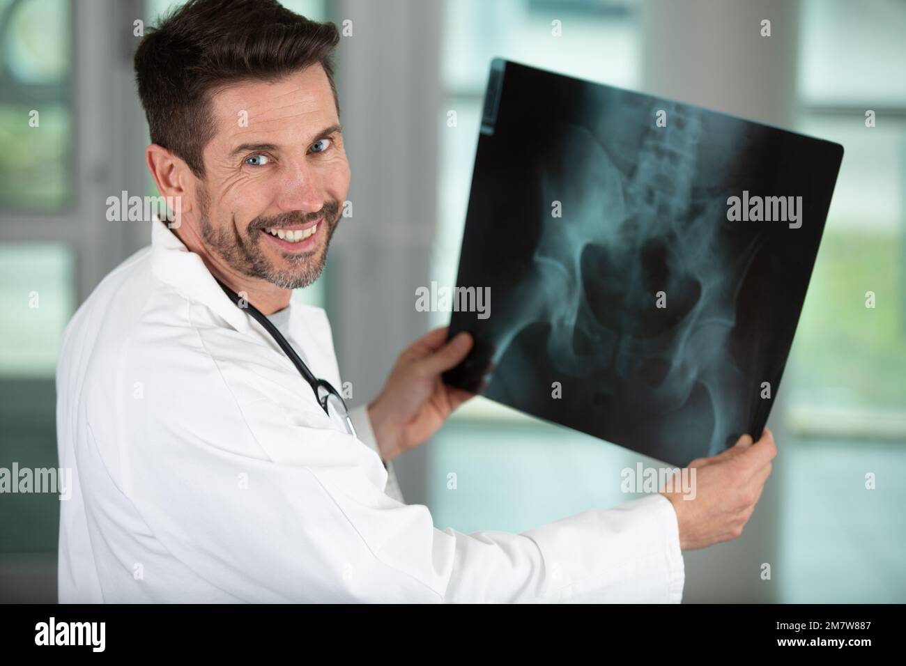 happy doctor looking at magnetic resonance imaging Stock Photo - Alamy