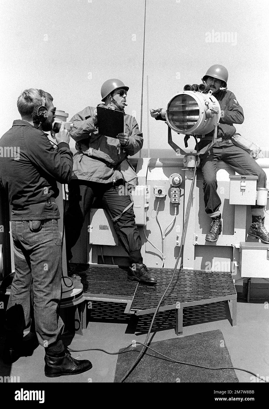 Signalman 3rd Class (SM3) Steve Woods, using a signal searchlight, SM2 ...