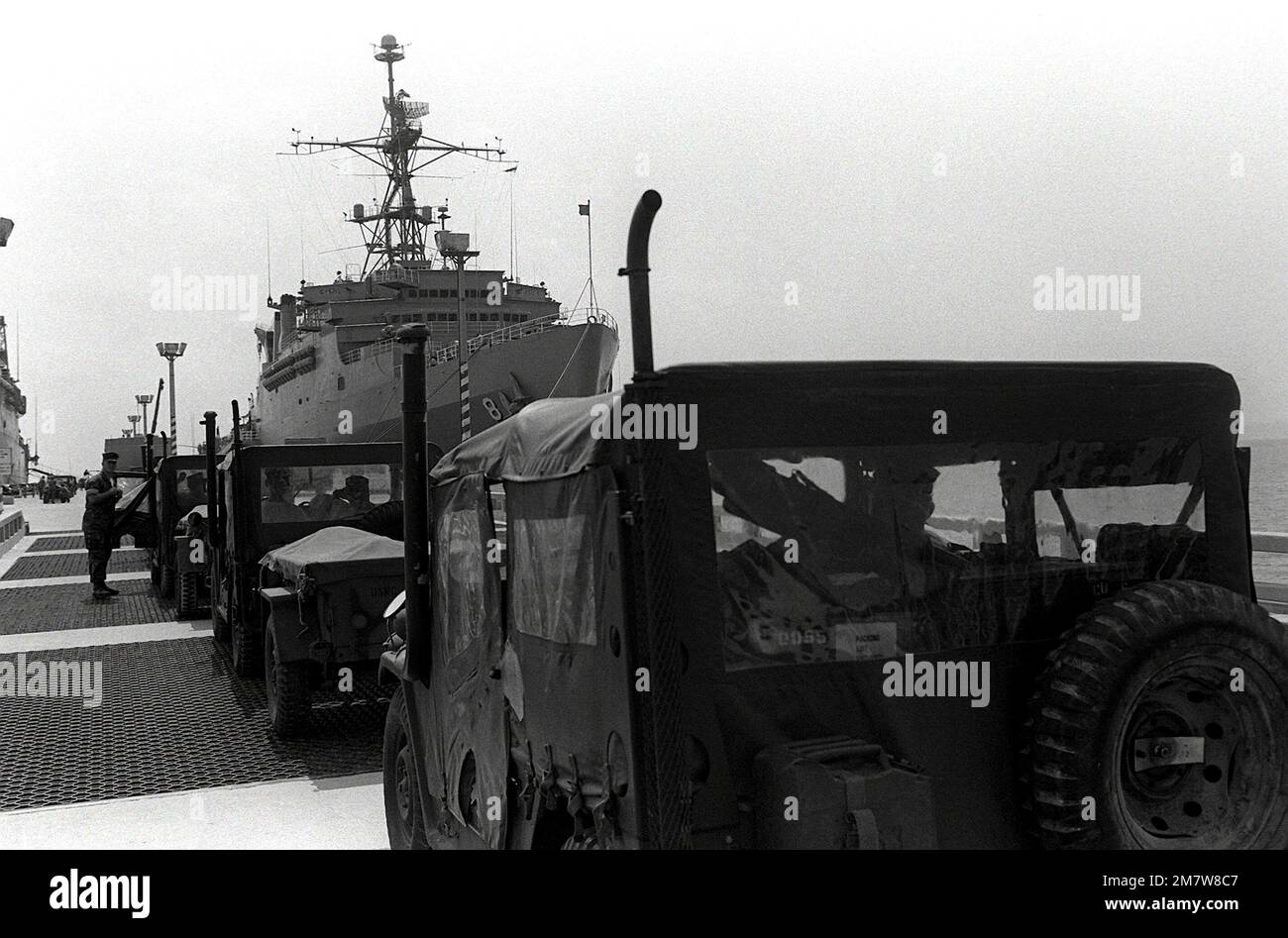 U.S. Marine jeeps are lined up waiting to be loaded aboard the ...