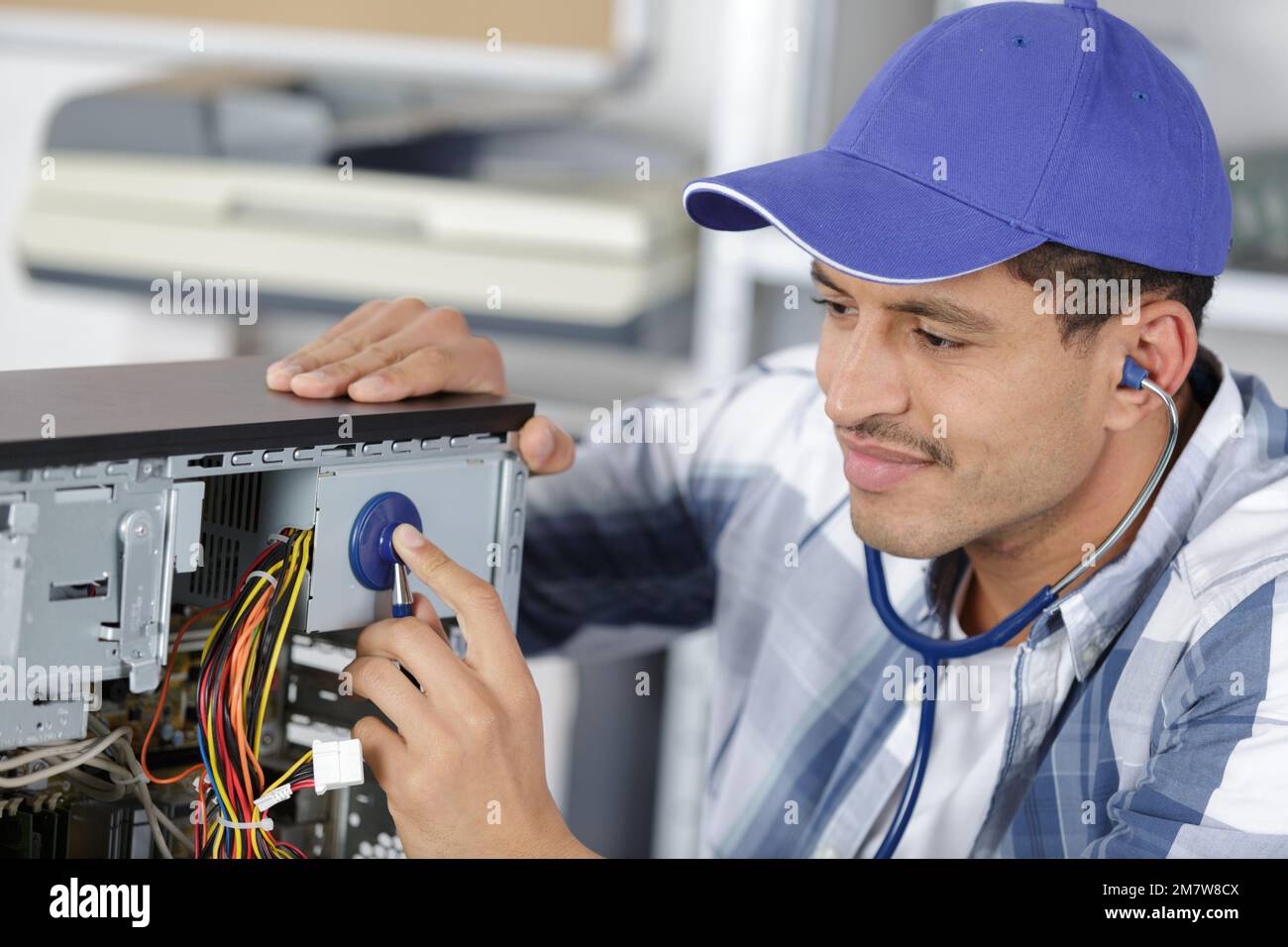 man fixing computer with an stethoscope Stock Photo - Alamy
