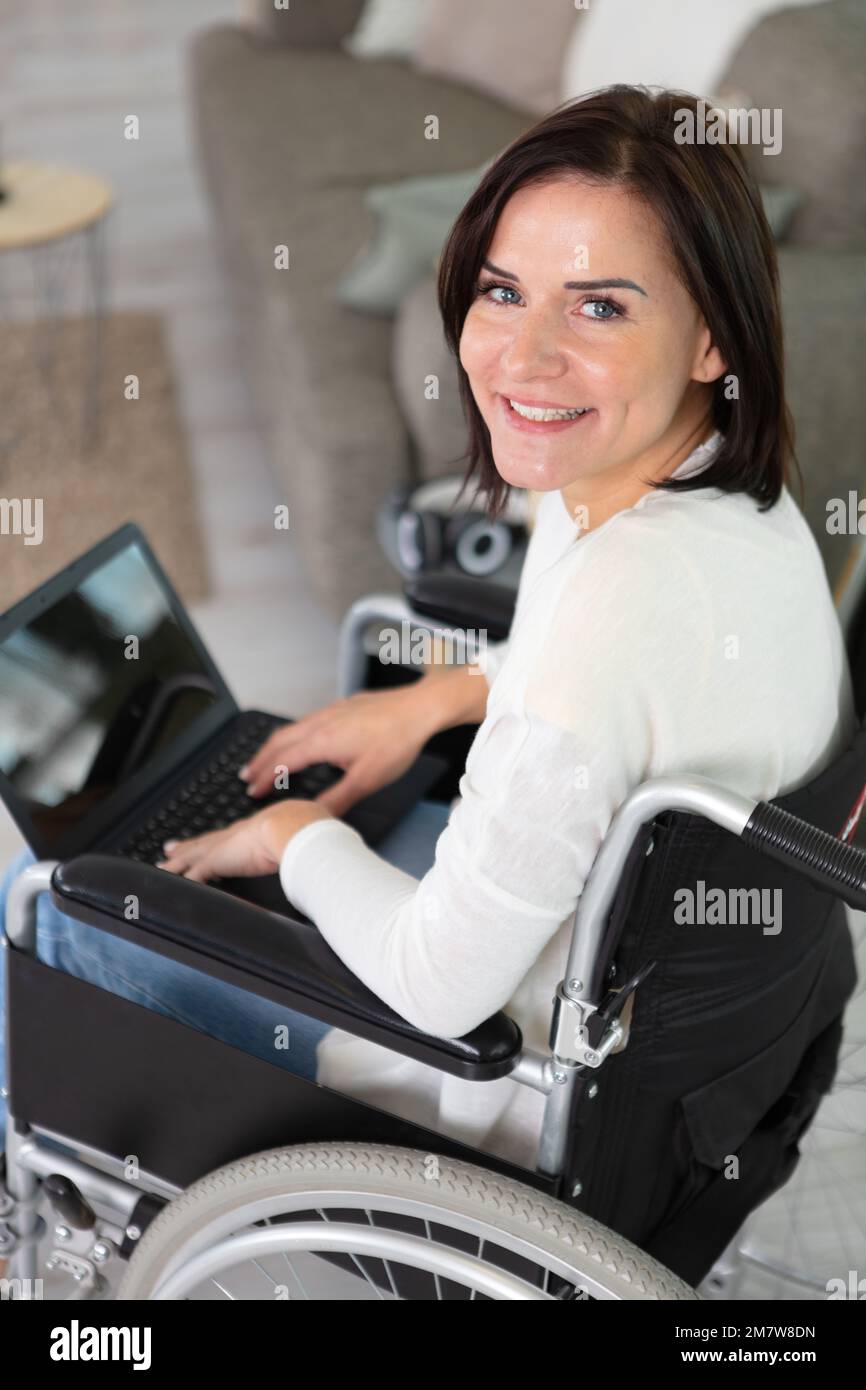 smiling young beautiful disabled woman in a wheelchair Stock Photo - Alamy