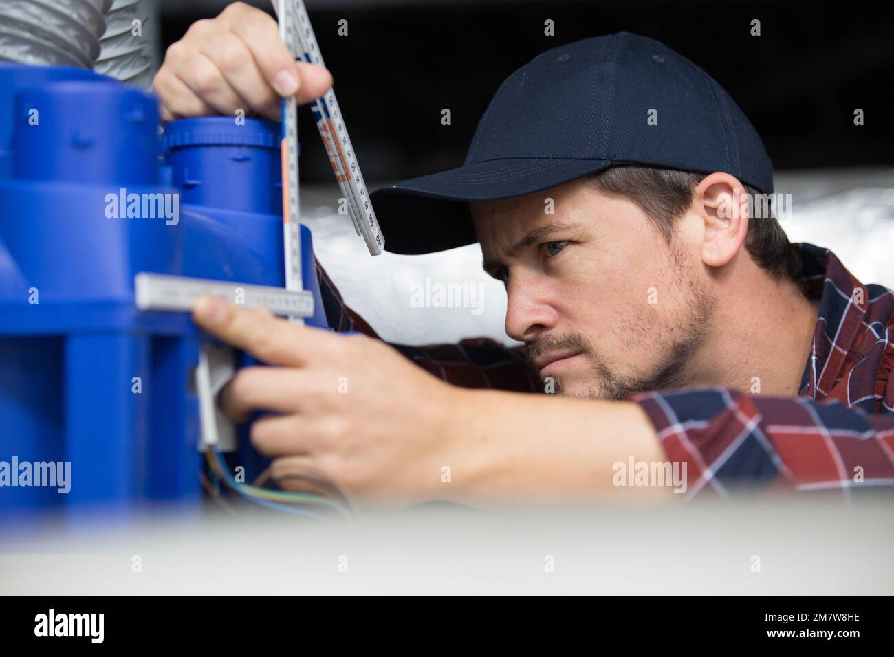 contractor measuring a ventilation unit Stock Photo - Alamy