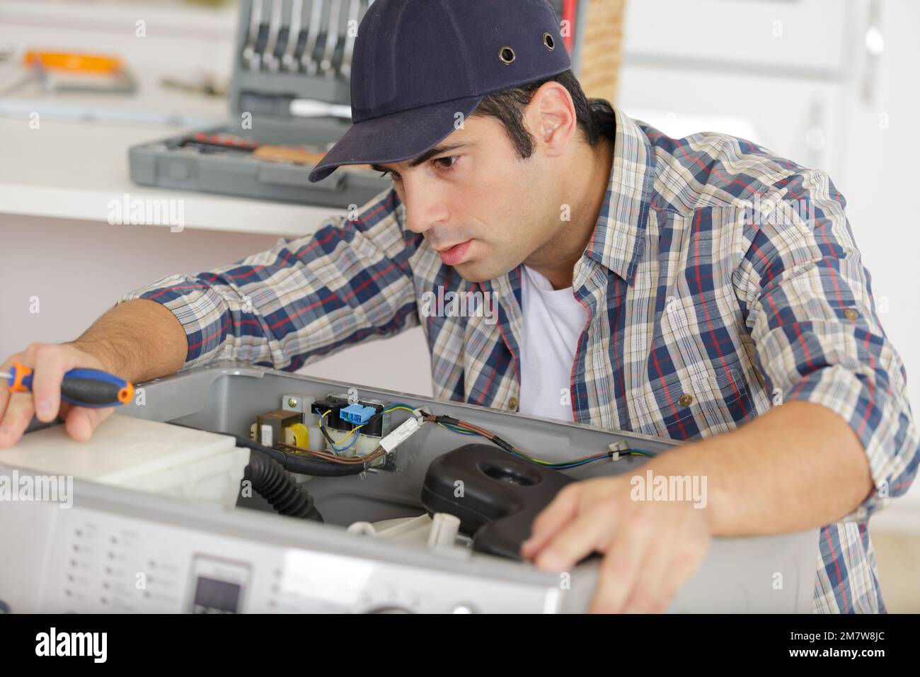man checking a broken machine Stock Photo - Alamy