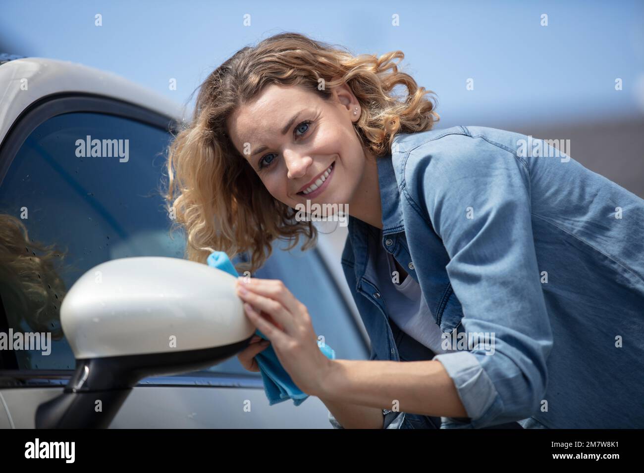 beautiful woman looking in car back rear-view mirror Stock Photo - Alamy