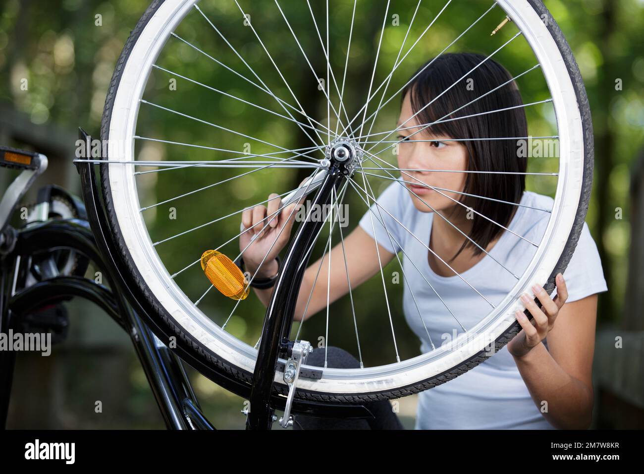 Girl fixing bike hi-res stock photography and images - Alamy