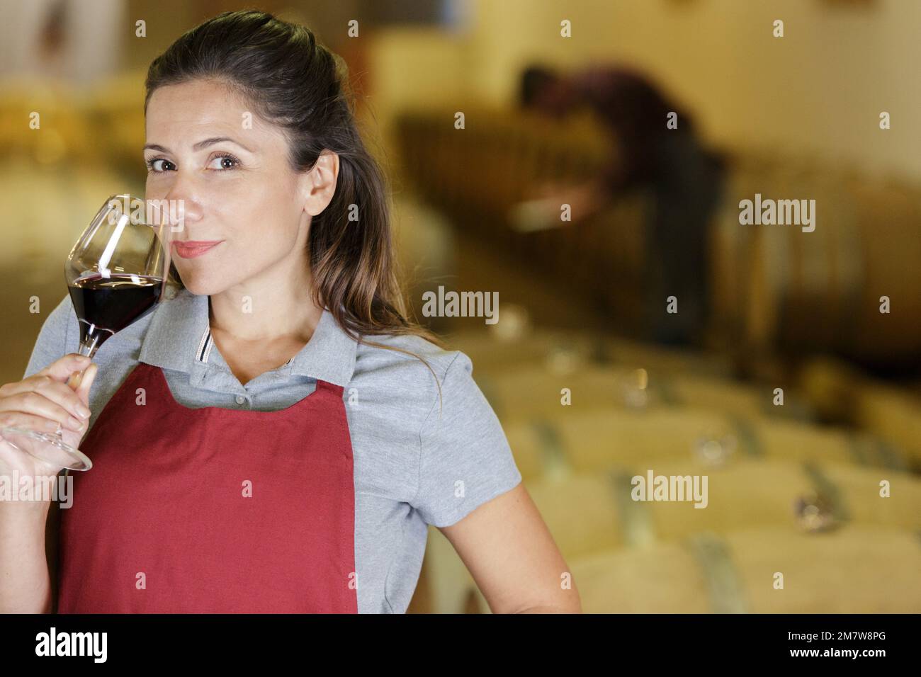 beautiful woman sommelier tasting red wine in wine cellar Stock Photo ...
