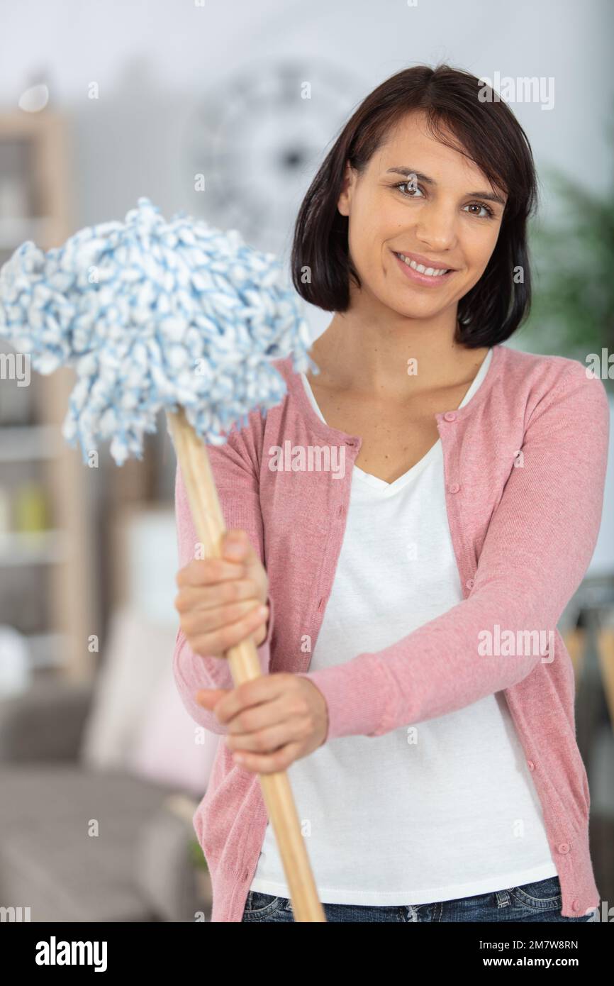 portrait of young lady holding a mop Stock Photo - Alamy