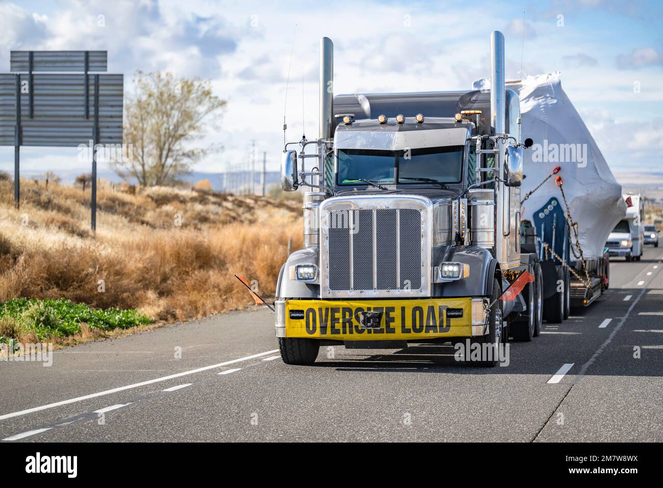 Industrial gray classic big rig semi truck tractor with oversize load ...