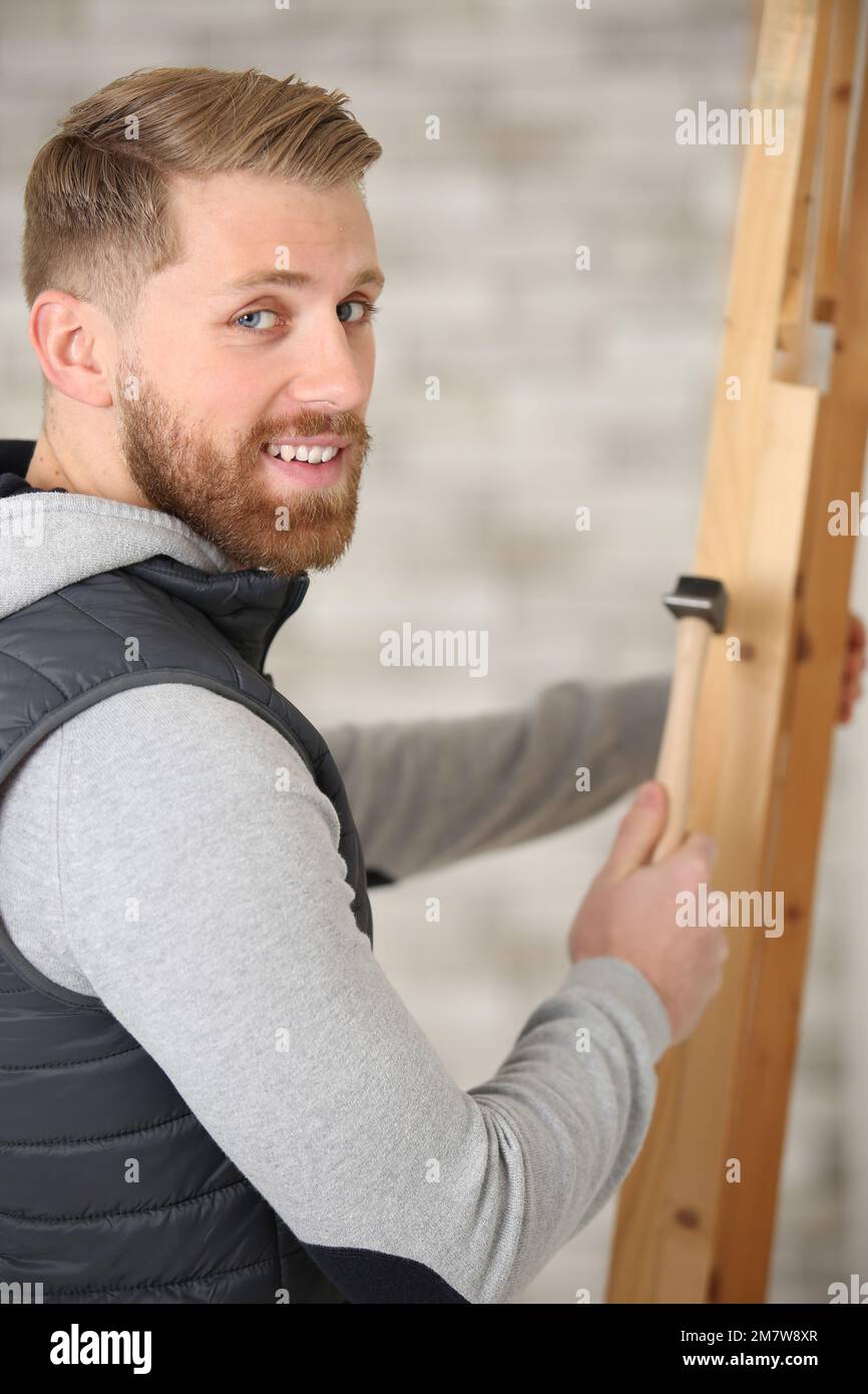 male worker holding a beam Stock Photo - Alamy