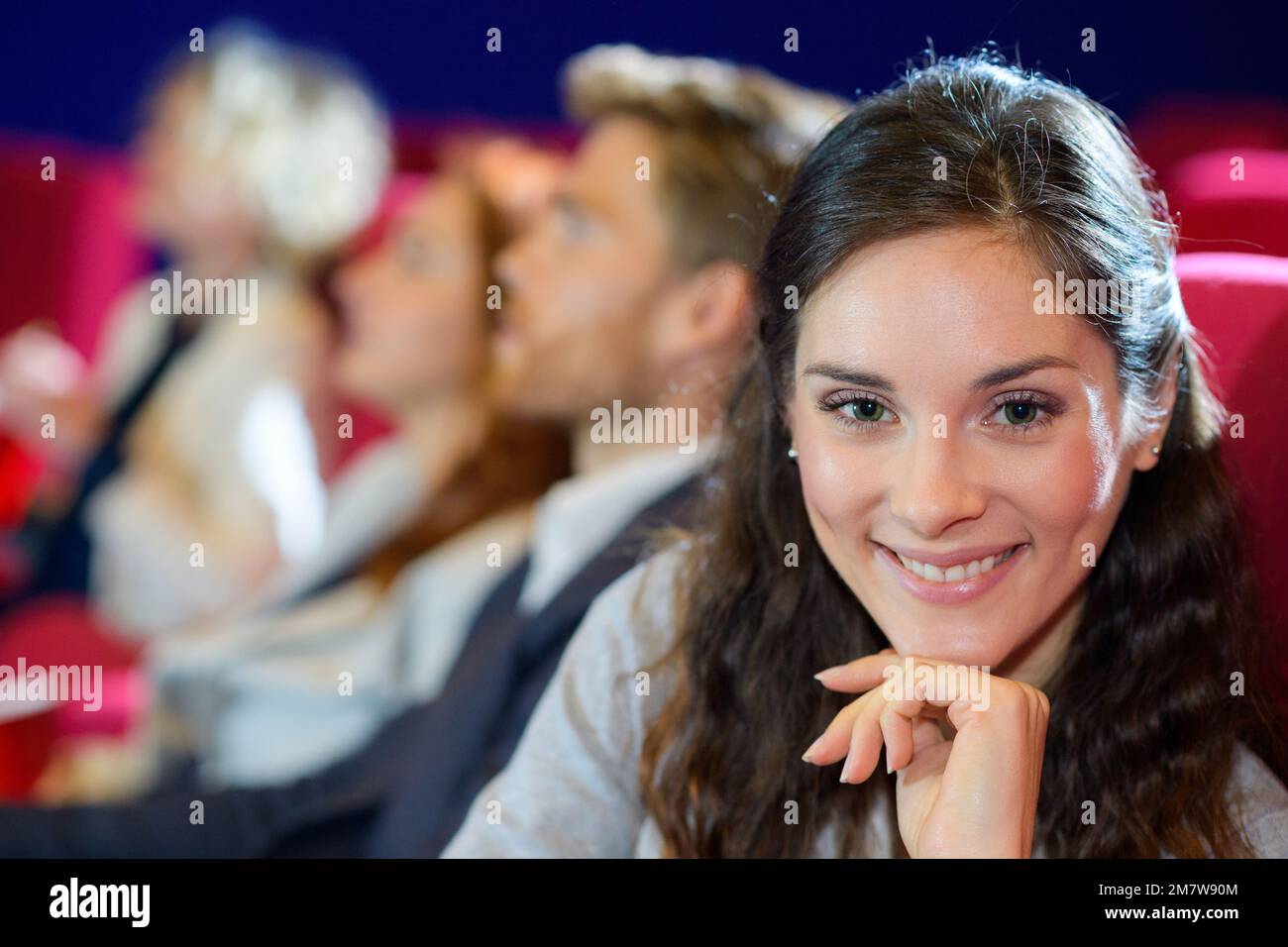 woman in cinema posing and smiling Stock Photo - Alamy