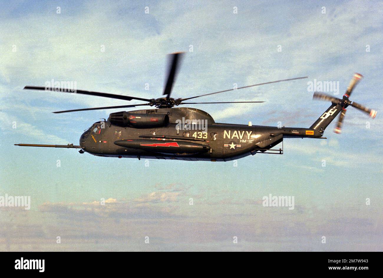 An air-to-air left side view of a Helicopter Mine Countermeasures ...