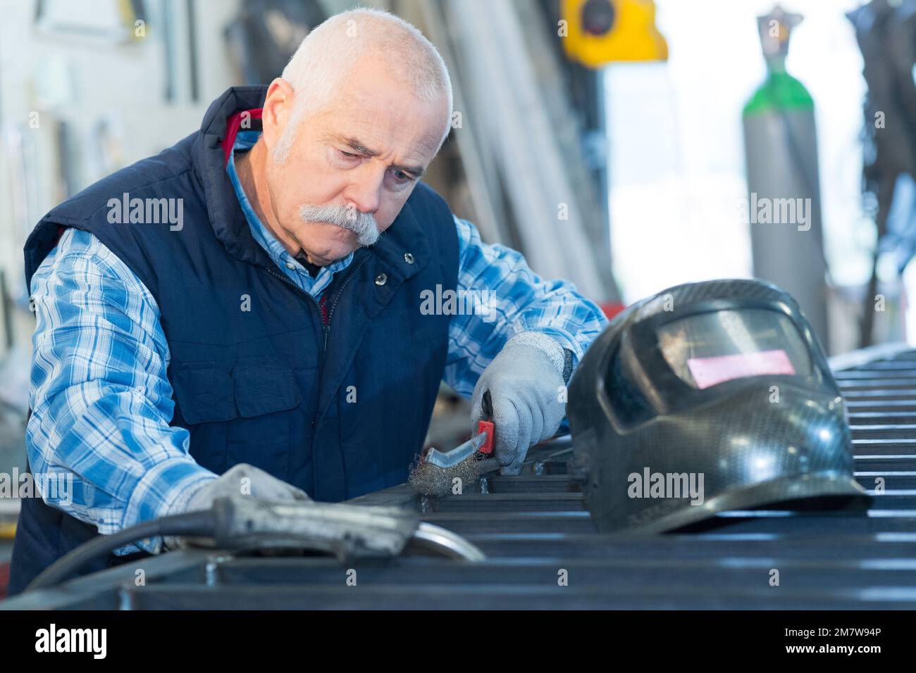 engineer wire brushing weld Stock Photo - Alamy