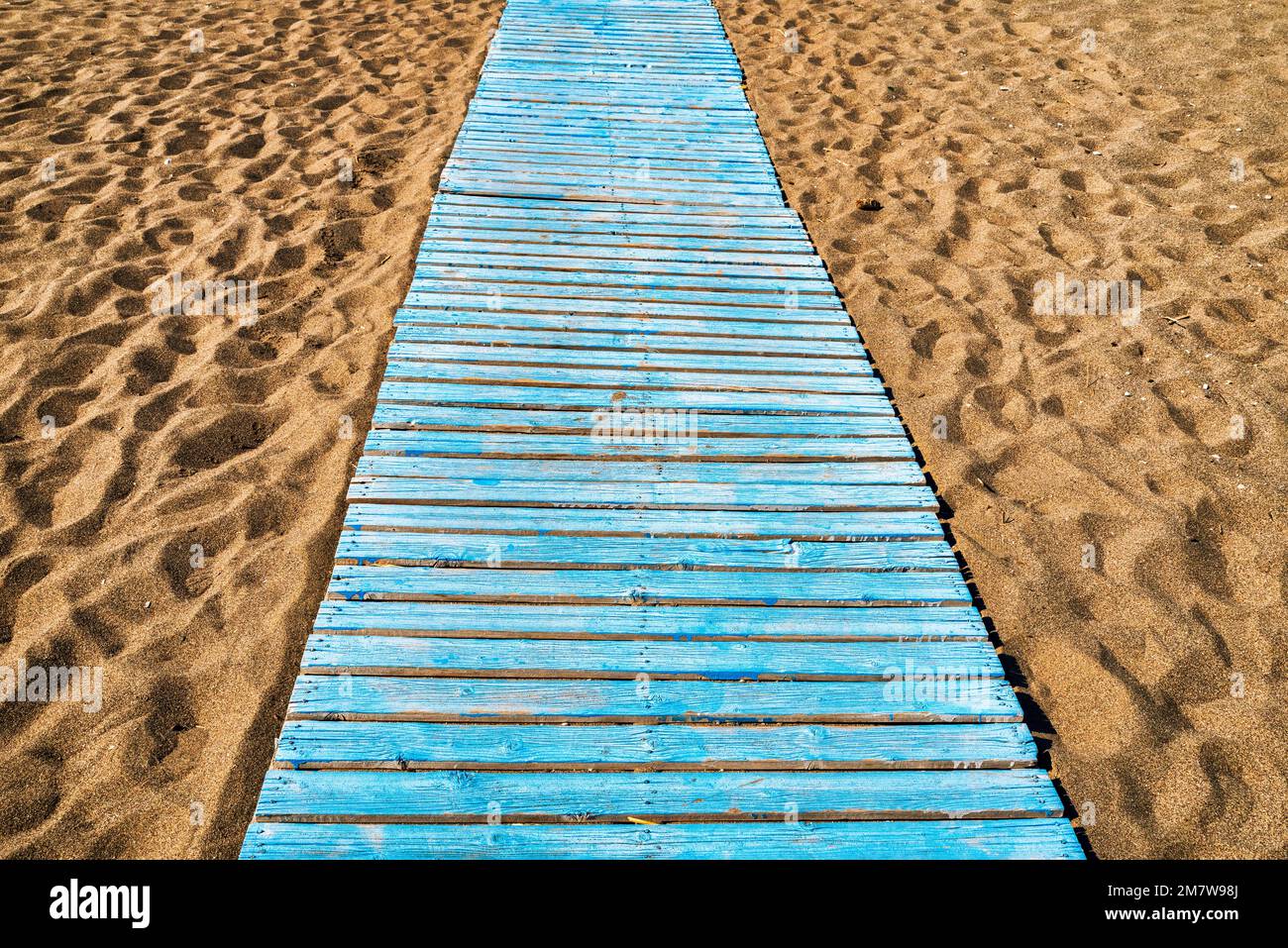 Blue wooden path through sand on the beach in summer resort Stock Photo ...