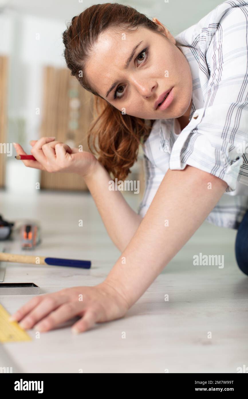 confused young woman working with wood Stock Photo - Alamy