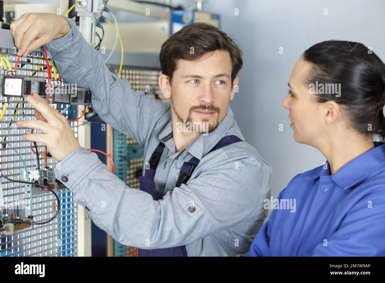 electrician and his apprentice at work Stock Photo - Alamy