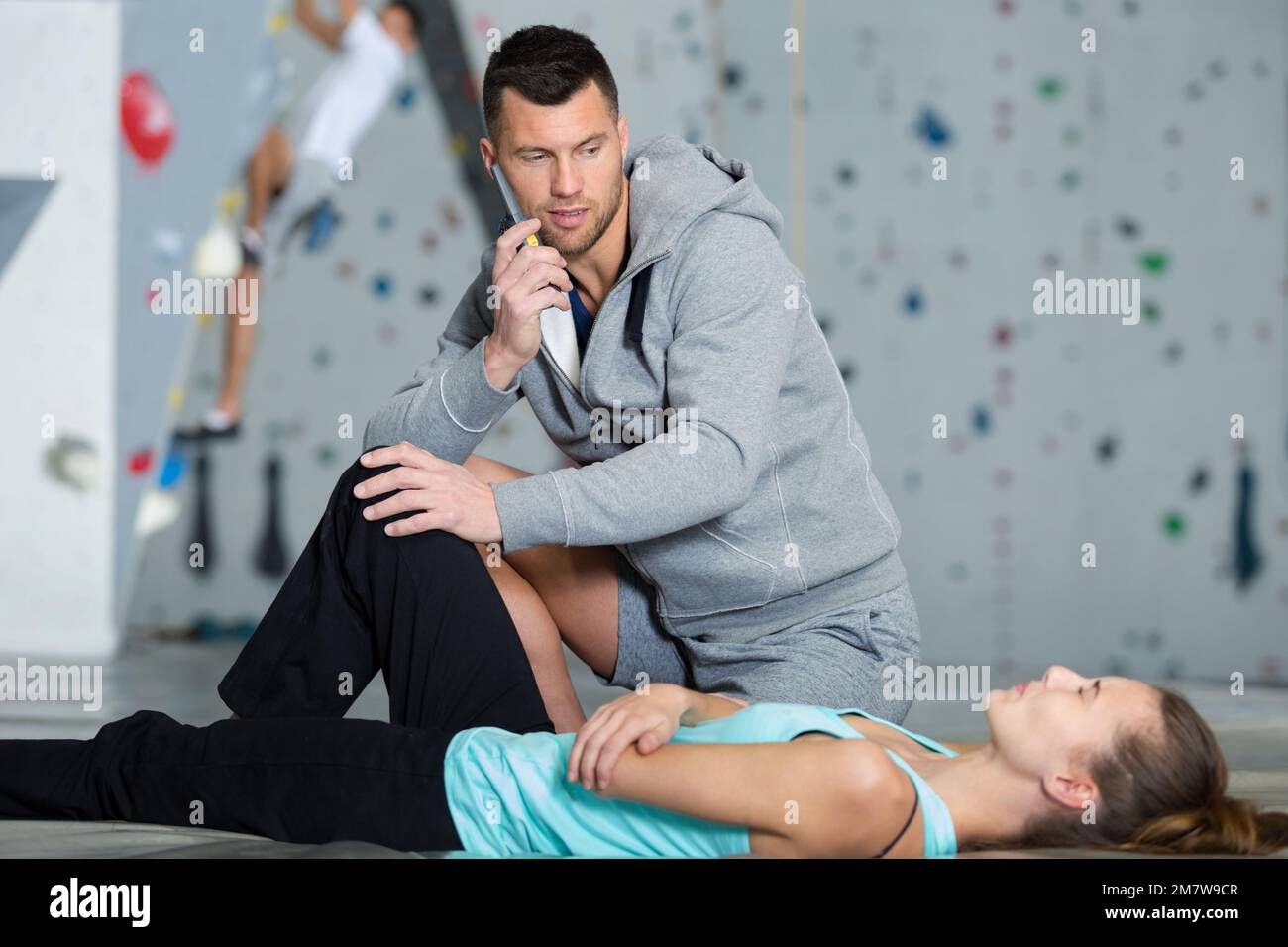 woman having leg injury after wall climbing Stock Photo - Alamy