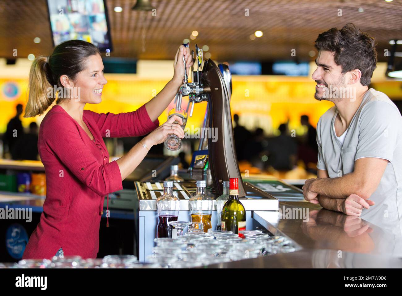 pretty waitress standing at the counter talking to a customer Stock ...