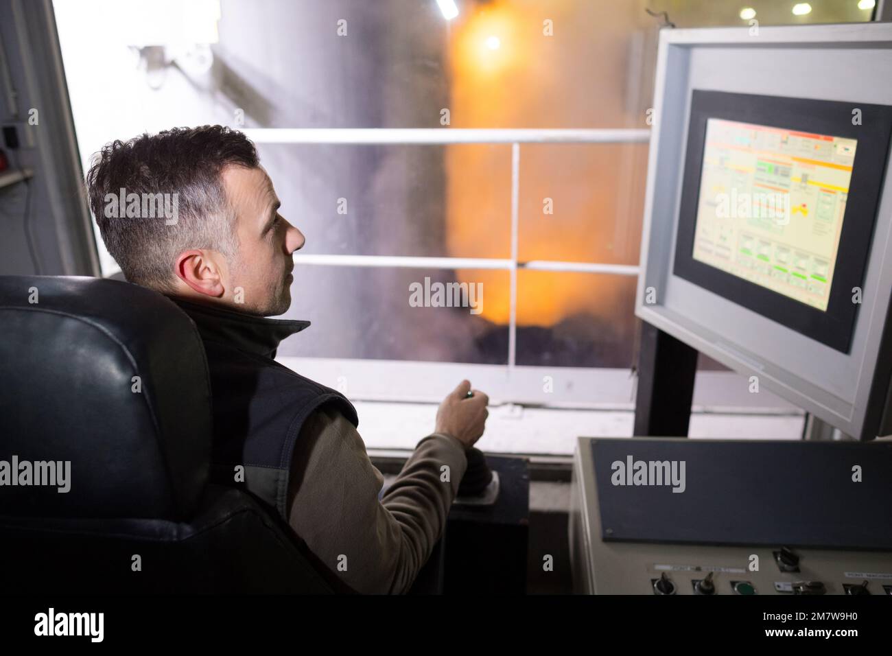 operative watching computer monitor on industrial site Stock Photo - Alamy